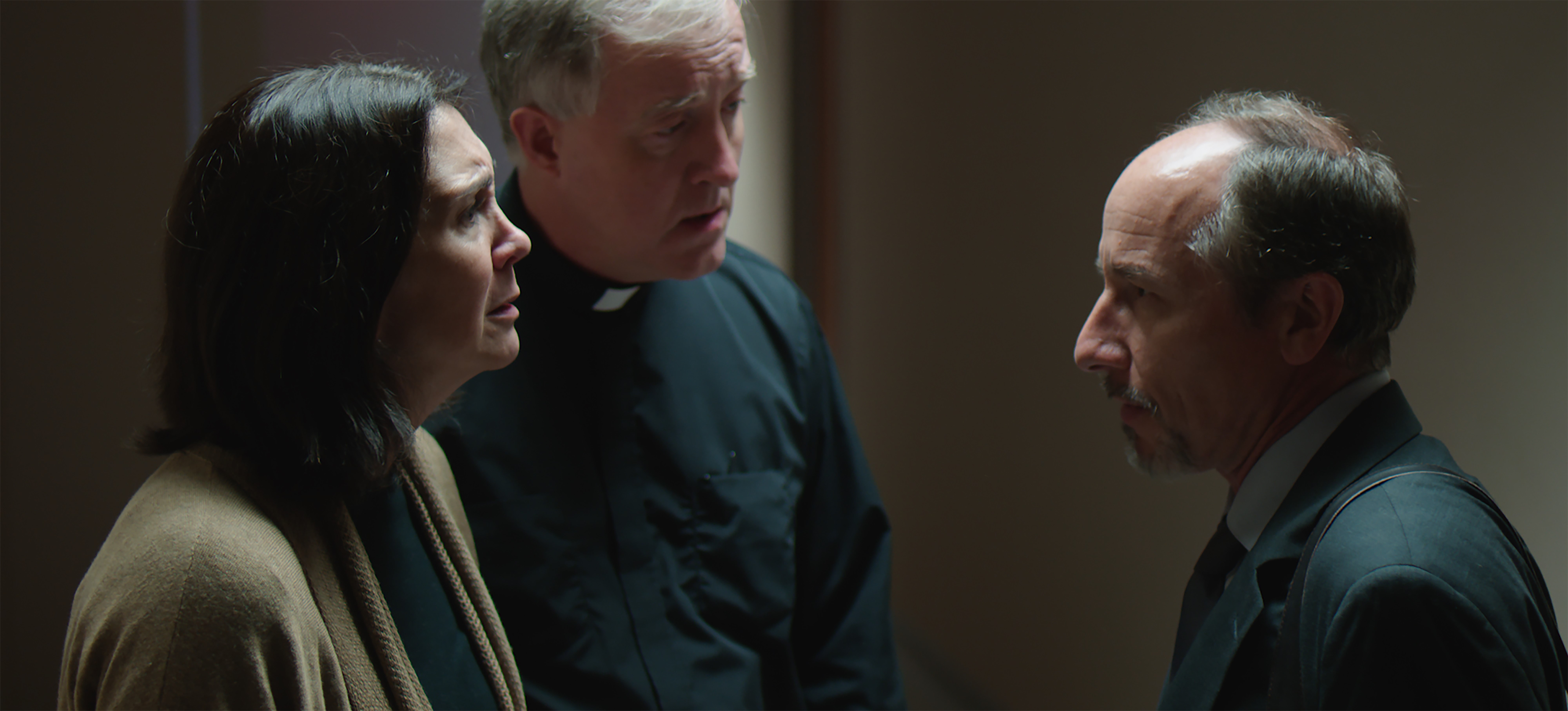 Ingrid and Father Peter outside court | Mitch Teemley